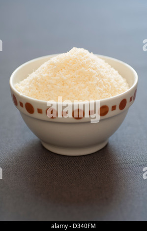 close-up of whole parmesan cheese, shavings, and grated cheese on a ...
