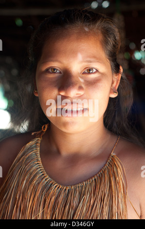 Peru, Amazon River. Traditional thatch huts built along the shore of ...