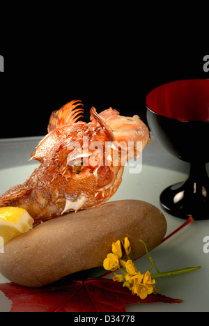 Asian deep fried Lion fish served with lemon wedge Stock Photo - Alamy