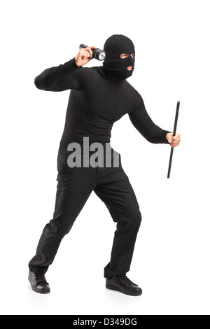 Full length portrait of a robber with robbery mask holding a flashlight ...