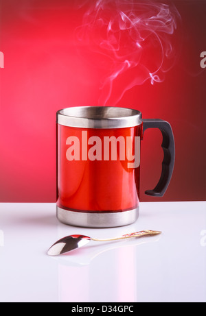 Red travel mug with hot tea spoon Stock Photo - Alamy