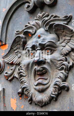 Italy - Mask on an old door Stock Photo - Alamy
