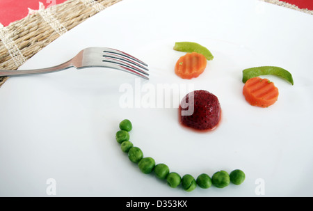 Plate's of funny faces made of vegetables and fruit, indoors Stock ...