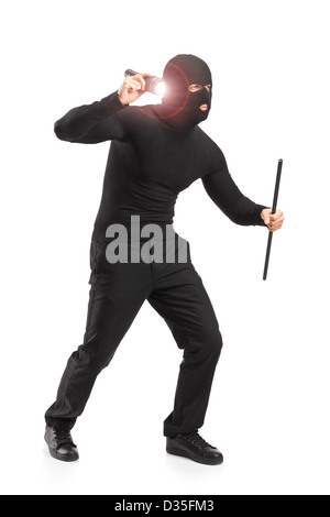 A robber with robbery mask holding a flashlight and piece of pipe Stock ...