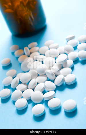 Scattered pharmaceutical medicine pills, tablets and capsules on dollar ...