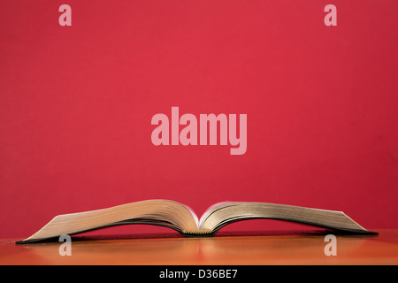 Open book lying on the table in the public library Stock Photo - Alamy