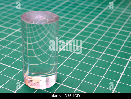 Perspex cylinder showing refraction of light on a square grid Stock ...