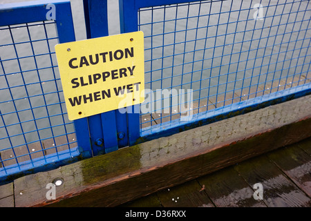Caution warning sign slippery deck dangerous wet Stock Photo - Alamy