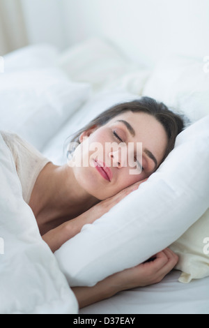 Young woman smiling while sleeping in her bed at home. Relax concept ...