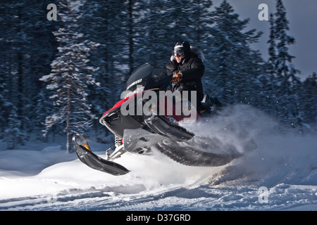 Snowmobile action, jumping on snow Stock Photo - Alamy