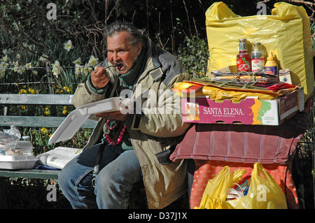 homeless man sitting on bench Stock Photo - Alamy