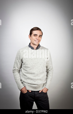 Smiling man with hands in pockets at olive orchard Stock Photo - Alamy
