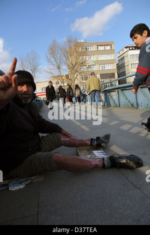 Istanbul, Turkey, a beggar sitting on a bridge in Bayrampasa Stock ...