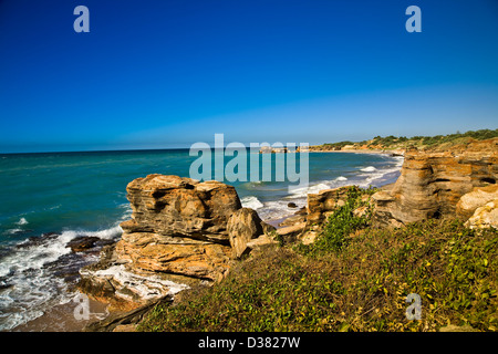 A picturesque cove rimmed in red sandstone near the port in Broome ...