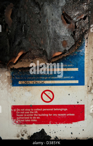Fire Action Safety Sign Partly burnt in factory fire Stock Photo - Alamy