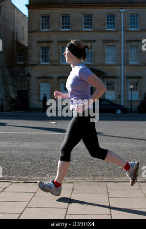 fitness girl runner running in sportswear on yellow background. Woman ...