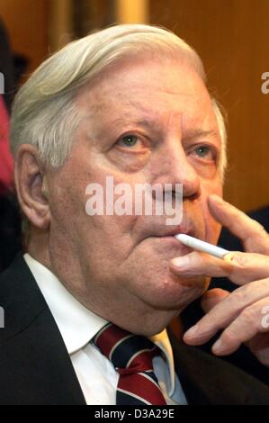 German former chancellor Helmut Schmidt (L) smokes a cigarette with ...