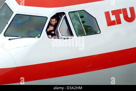 (dpa) - A pilot of the German LTU Airline sits in the cockpit of a LTU ...