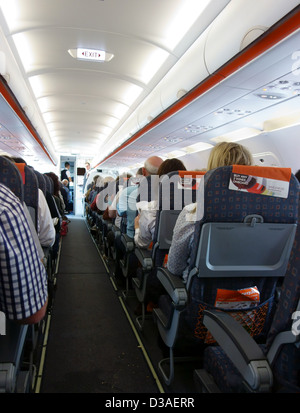 Interior of Easy Jet easyjet plane airplane with passengers seated ...