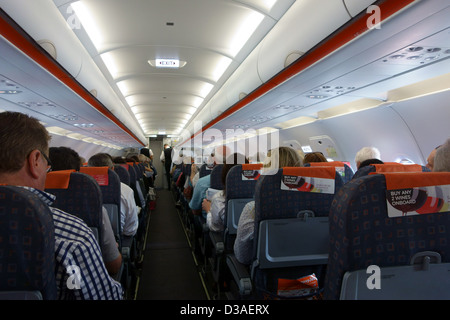 Interior of Easy Jet easyjet plane airplane with passengers seated ...