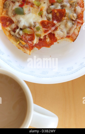 Hot cheese pizza and a Cup of coffee on a gray background, top view ...