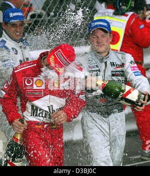 First placed McLaren Formula One driver Jenson Button of Britain (L ...