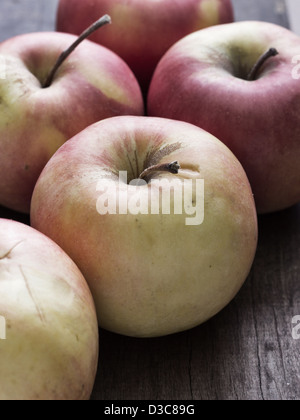A large red apple on a wooden surface, a close-up shot Stock Photo - Alamy
