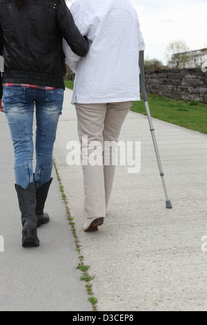 Helping hand, doctor and woman with cane in home visit, physiotherapy ...