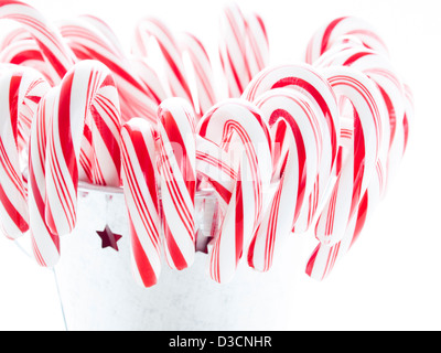Peppermint candy canes in metal bucket on white background Stock Photo ...