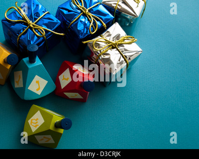Colorful dreidels with presents on blue background Stock Photo - Alamy