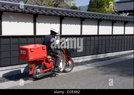 Japan Post mail delivery man on motorcycle. White motorcycle helmet ...