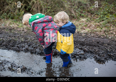 Children walking through Muddy Puddles Stock Photo - Alamy