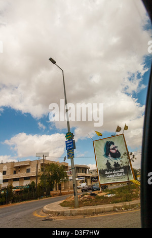 Billboards of Hassan Nasrallah under Hezbollah flags by highway in the ...