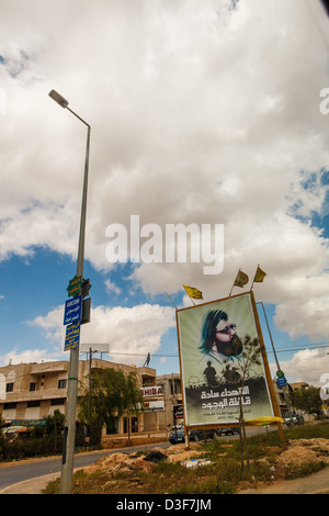 Billboards of Hassan Nasrallah under Hezbollah flags by highway in the ...