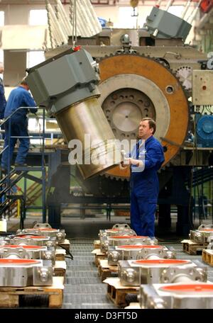 Employees work on diesel-engines at an assembly hall of the company SKL ...