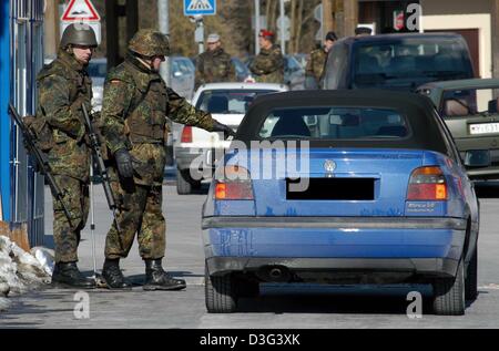 German Bundeswehr soldiers check cars and drivers during a road check ...