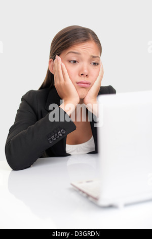 A frustrated and bored young Asian businesswoman or female financial ...