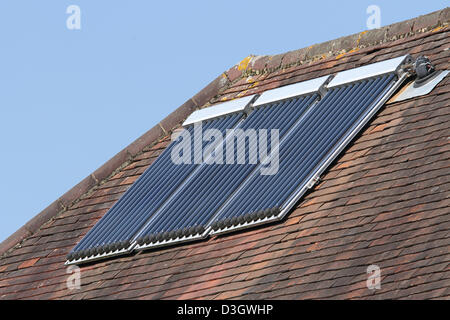 Solar hot water glass tube heating panel on tiled house roof Stock ...