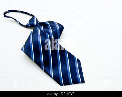 Blue rolled tie isolated on white Stock Photo - Alamy