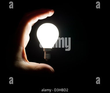 Hand with Floating Light Bulb Stock Photo - Alamy