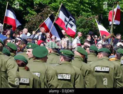 Police officers form a barrier in front of counter-protesters ...