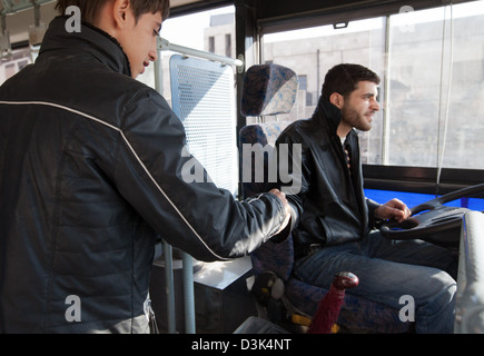Aleppo, Syria: People ride a public bus. Services are limited with only ...