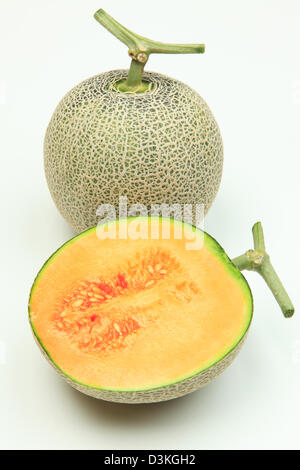 Two melons and one slice in focus, close-up, on a white background ...