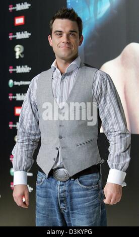 Singer Robbie Williams poses on the red carpet before the draw for the ...