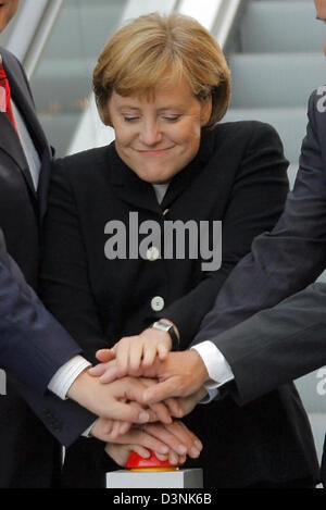 The German Chancellor, Angela Merkel, pushes Schaeuble`s wheelchair who ...