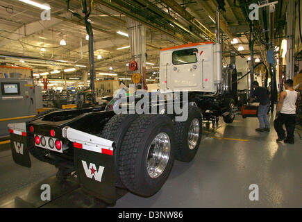 Employees of Freightliner work on a truck cabin at the Freightliner ...