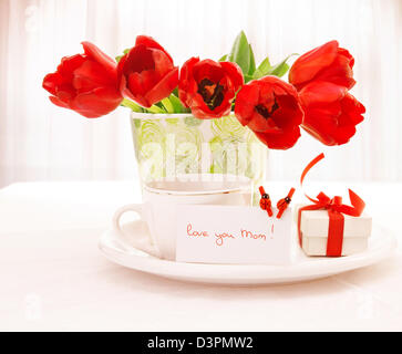 Gift box, flowers and a cup of tea in bed, top view Stock Photo - Alamy