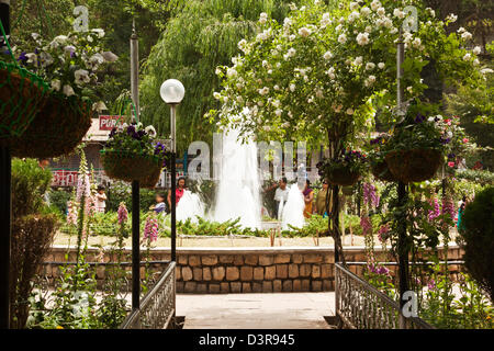 Tourists near a fountain at Company Bagh in Mussoorie, Uttarakhand ...