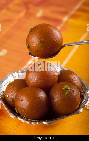 Close up of a Gulab Jamun in a small takeout cup Stock Photo - Alamy