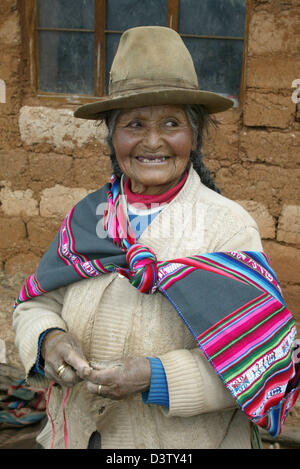 (dpa file) - An elder Peruvian woman tries to smile with her grandchild ...